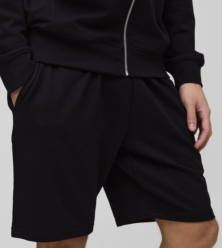 Buy BoohooMAN Relaxed Fit Mid Rise Basic Lightweight Shorts In Black ...