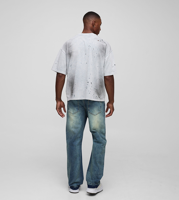 Buy BoohooMAN Ripped Knee Let Down Hem Straight Fit Jeans In Blue ...