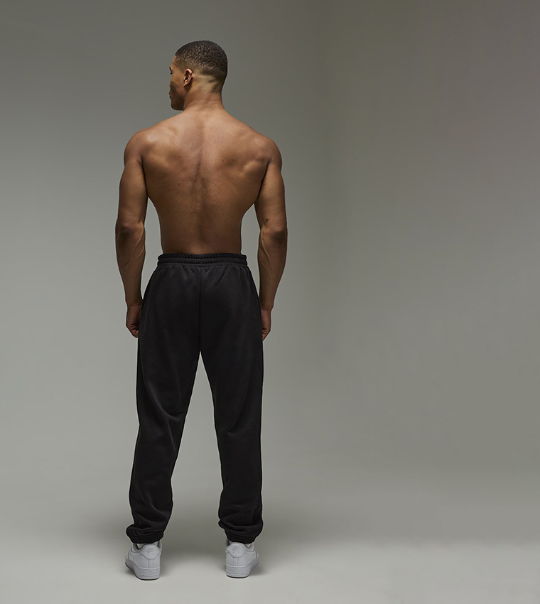 Buy BoohooMAN One More Rep Oversized Embossed Joggers In Black ...