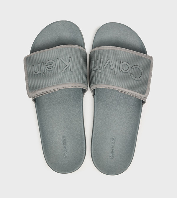 Buy Calvin Klein Logo Embossed Slides In Grey | 6thStreet Saudi Arabia